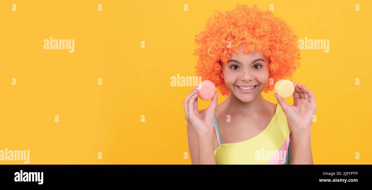 funny kid in wig hold french macaron. child wear swimsuit hold ...