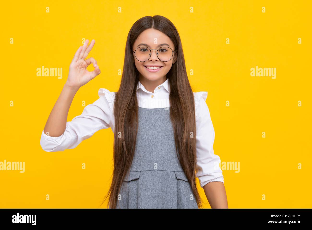 Portrait of a little teenager child girl showing okay gesture isolated ...