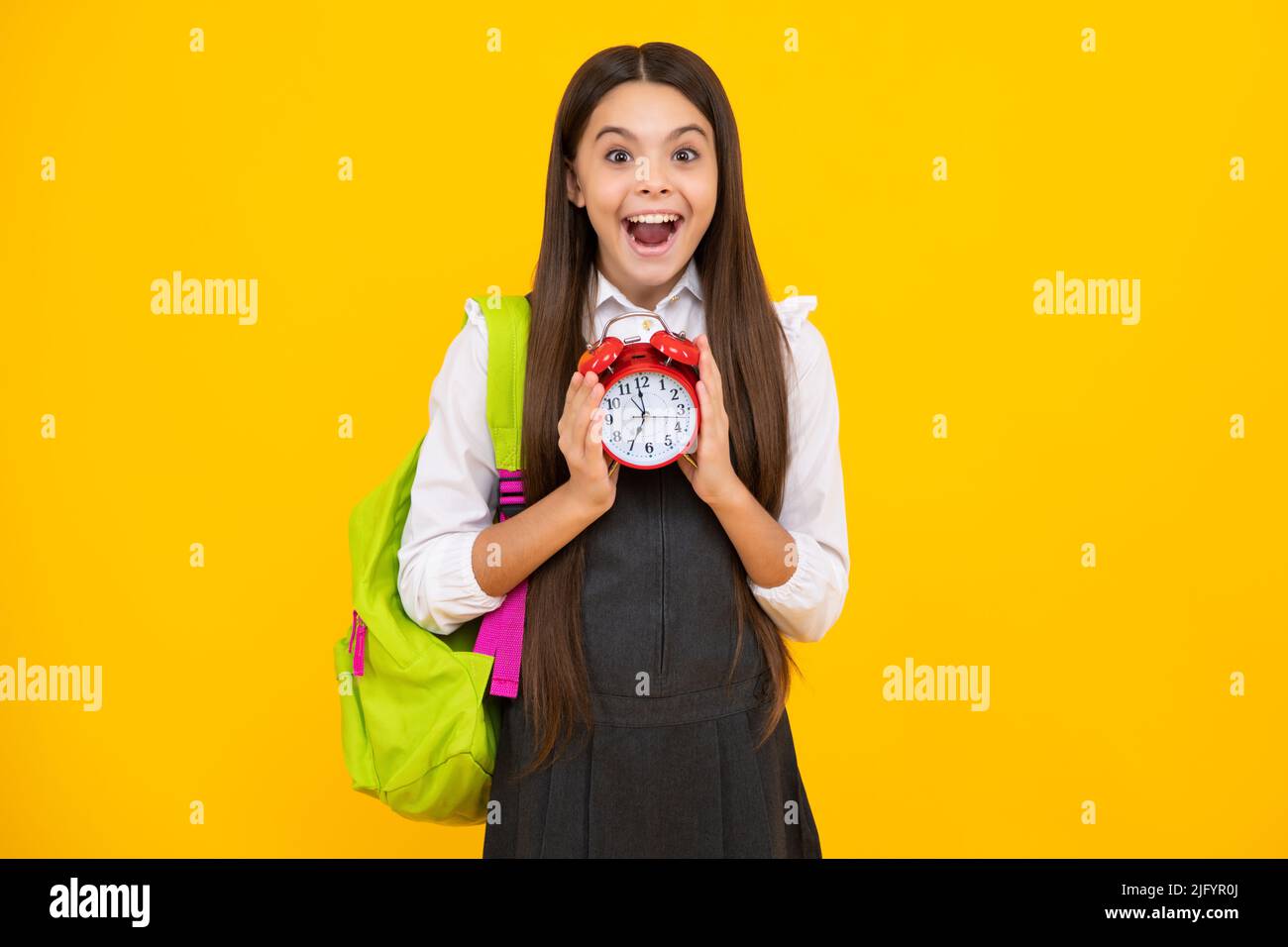 Back to school. Teenager school girl with backpack hold clock alarm ...