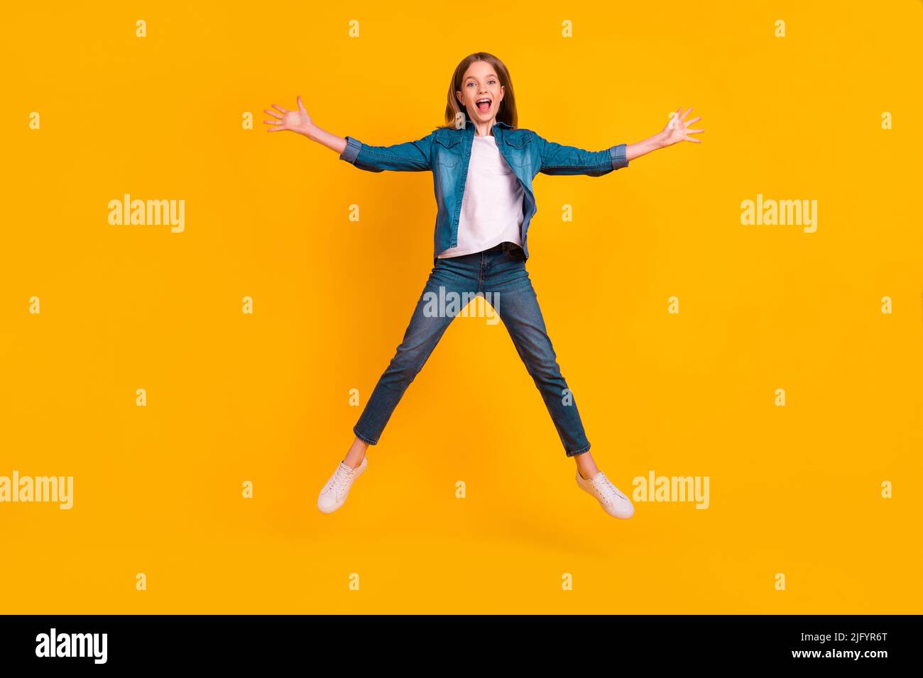 Full size photo of overjoyed energetic girl jumping make star figure ...