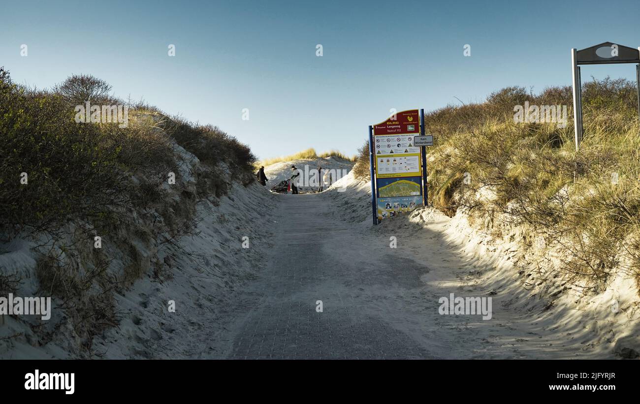 A view of a sand path with walking people Stock Photo - Alamy