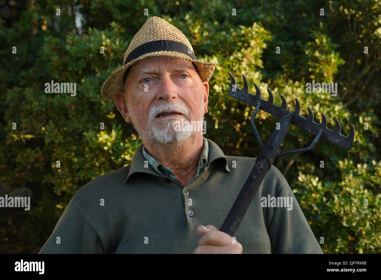 Portrait of an elderly Italian man with straw hat and blue eyes, in a ...