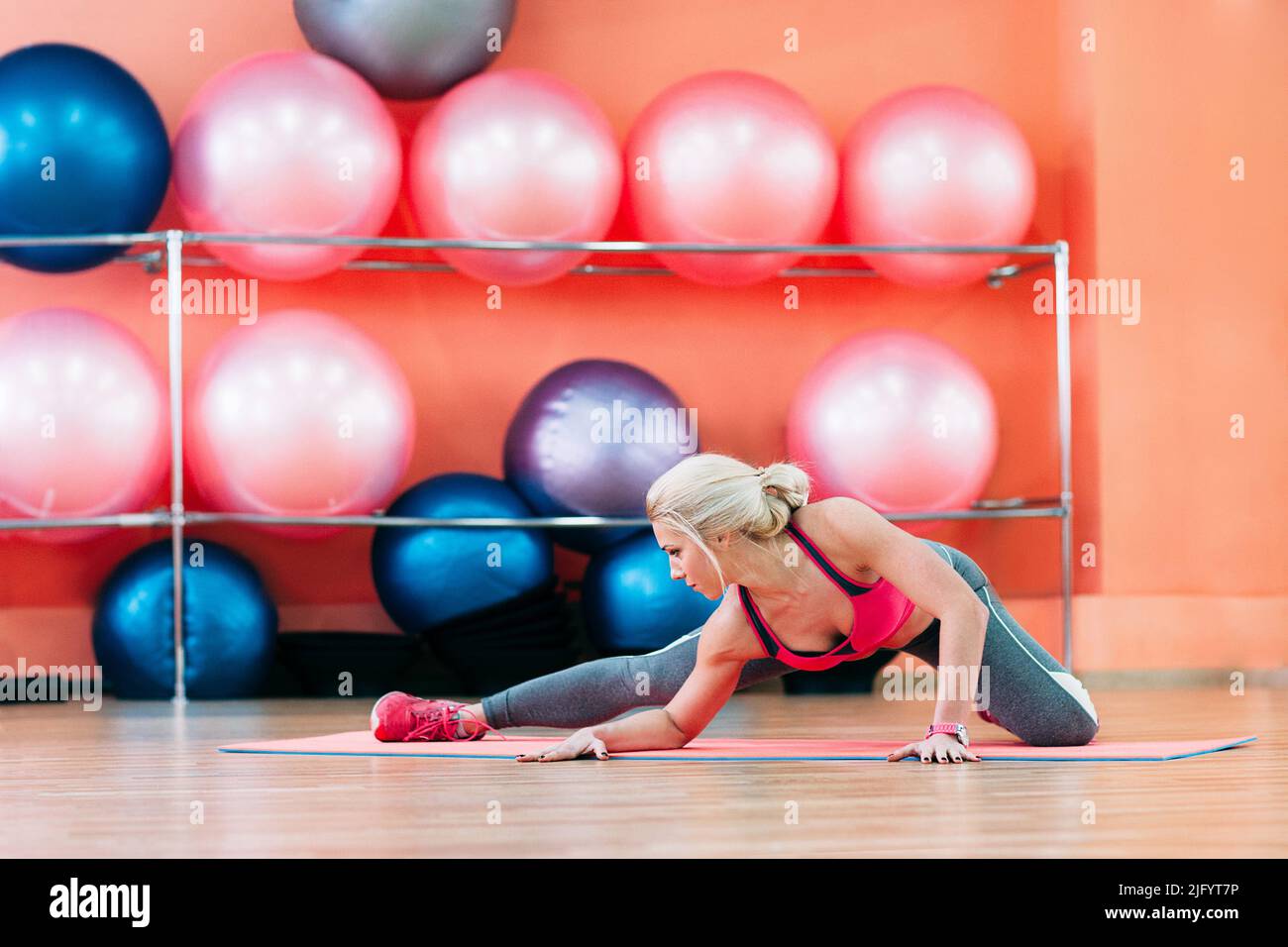 Young girl doing stretching in fitness studio Stock Photo - Alamy