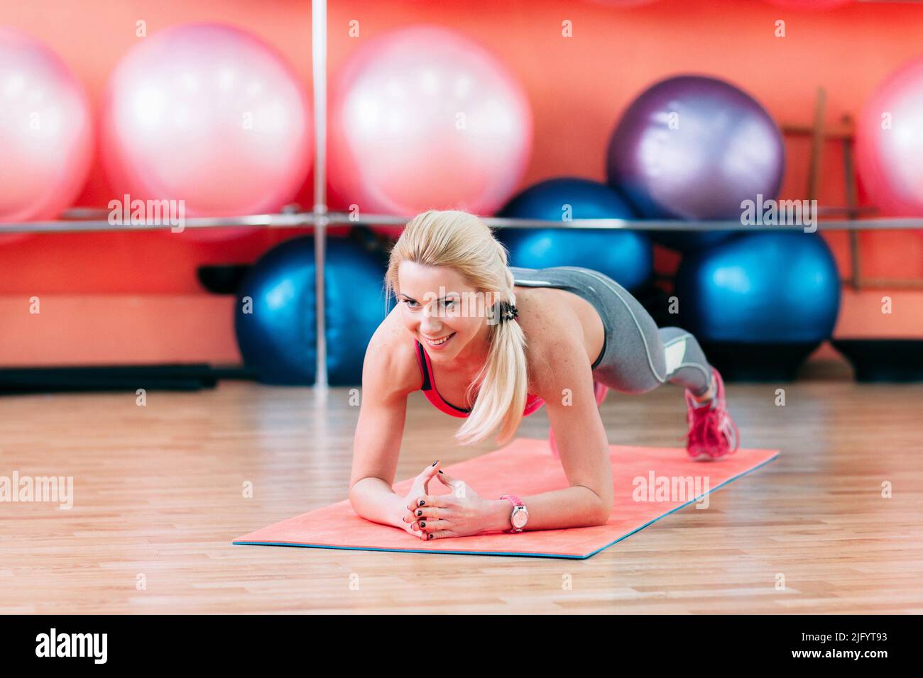 Young happy girl doing plank Stock Photo - Alamy