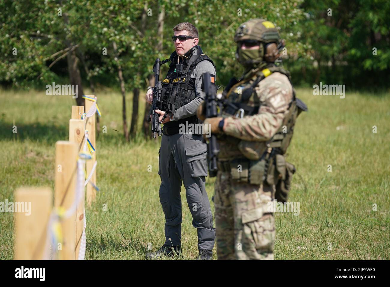 A member of the Ukrainian military (right) and the Garda Emergency ...