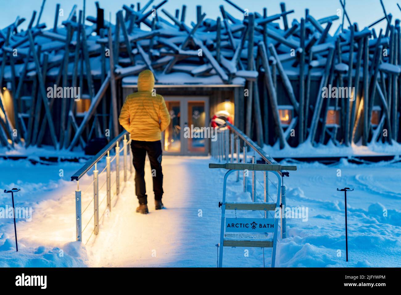 Person standing on the frozen walkway at dusk connecting the floating ...