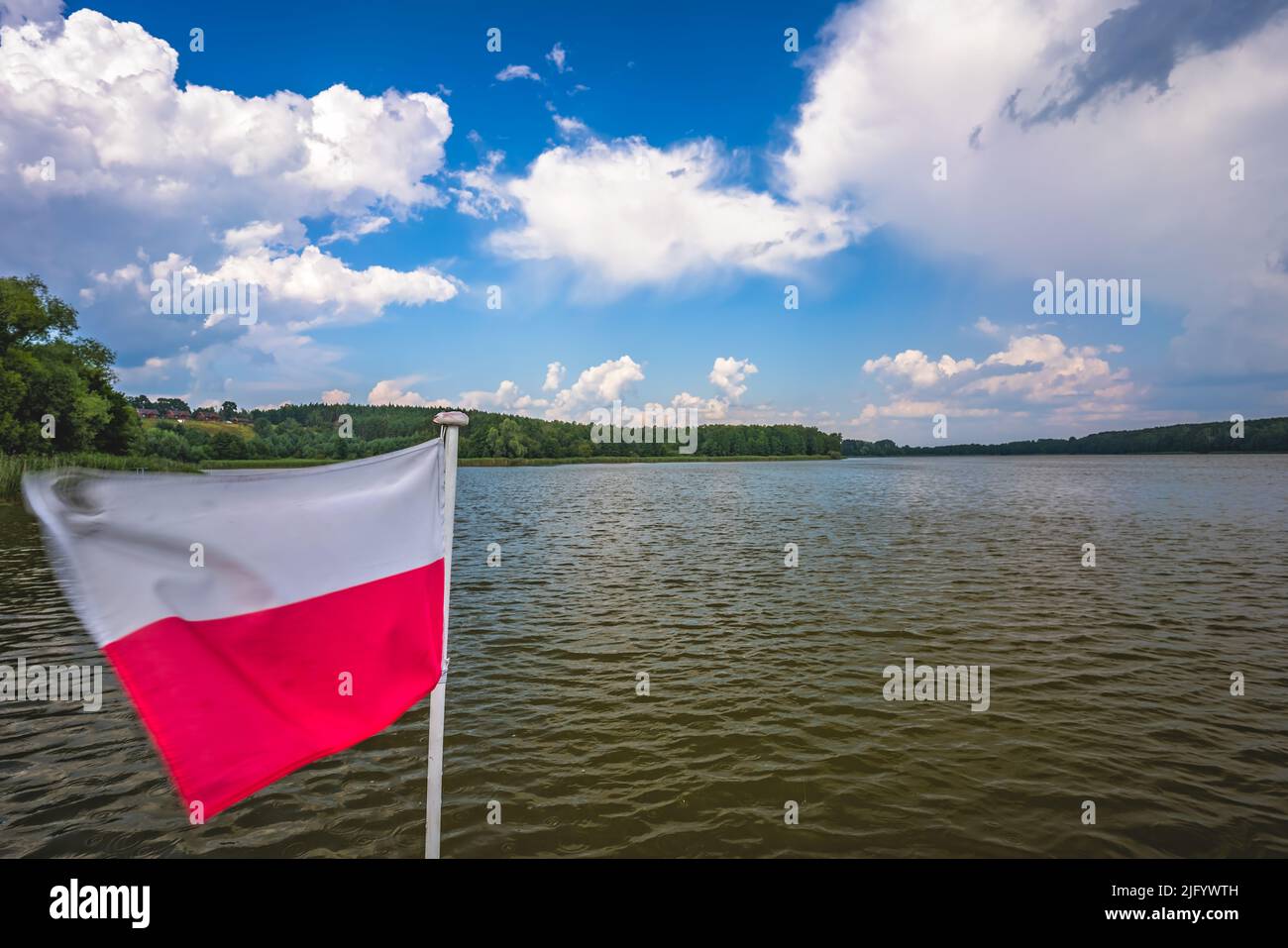 Polish flag fluttering on a boat on Jezioro Ostrowieckie in Poland ...