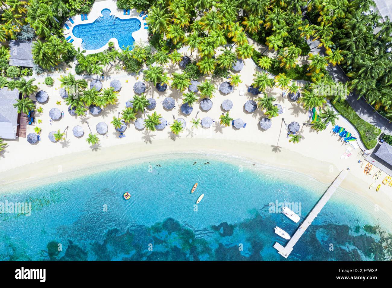 Canoes floating in the tropical lagoon of luxury resort with swimming ...