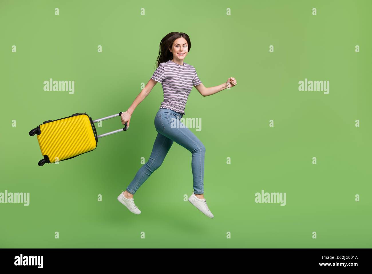 Full length body size view of attractive girl jumping with bag running ...