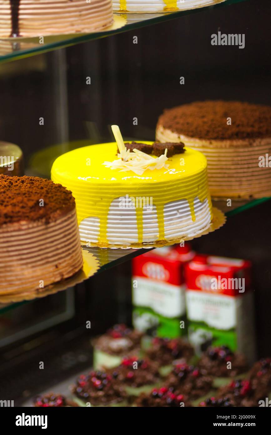 A vertical closeup of fresh cakes on shelves in a pastry shop Stock ...