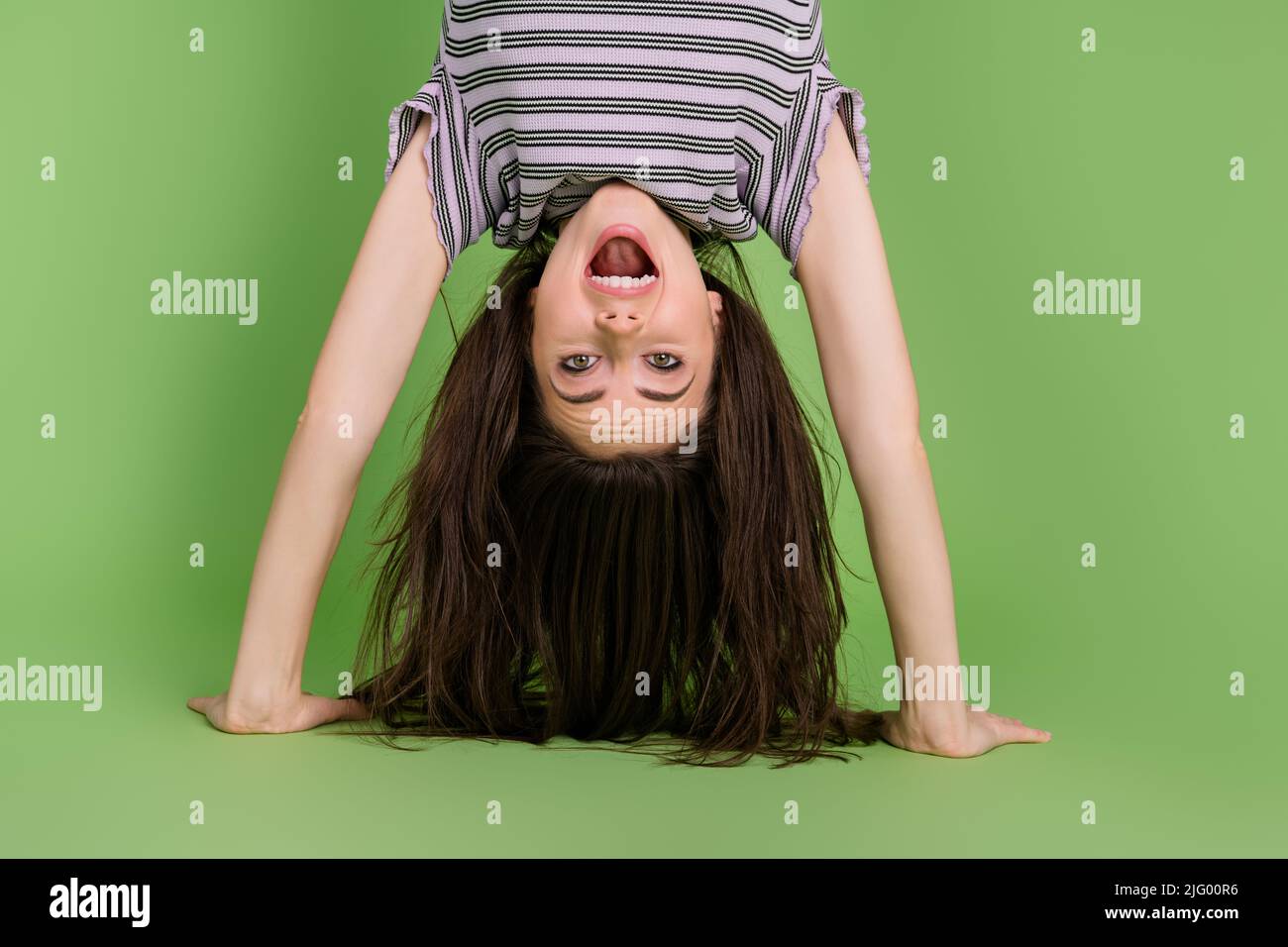 Upside down view portrait of attractive strong cheerful lucky girl ...