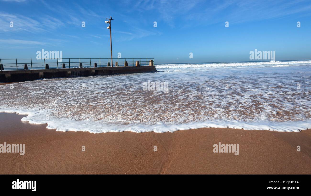 Beach sand ocean sea waves water wash around concrete tidal swimming ...
