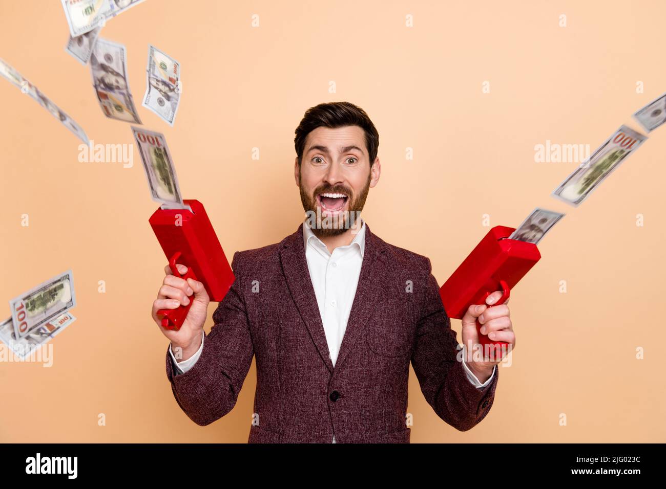 Portrait of overjoyed millionaire businessman hold gun shooting money ...