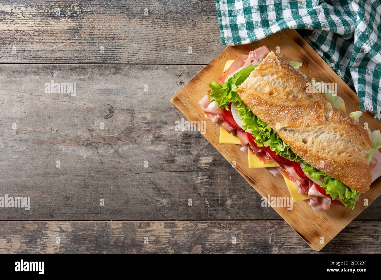 Submarine sandwich with ham, cheese, lettuce, tomatoes,onion ...