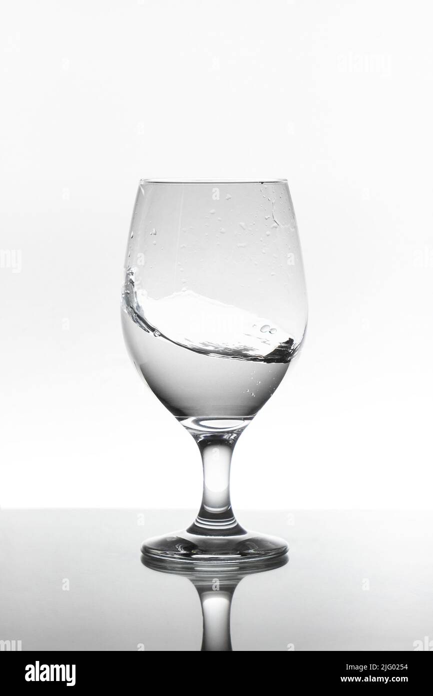 moving water inside a glass cup Isolated on white background Stock ...