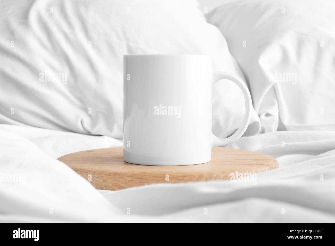 White mug mockup on the bed Stock Photo - Alamy