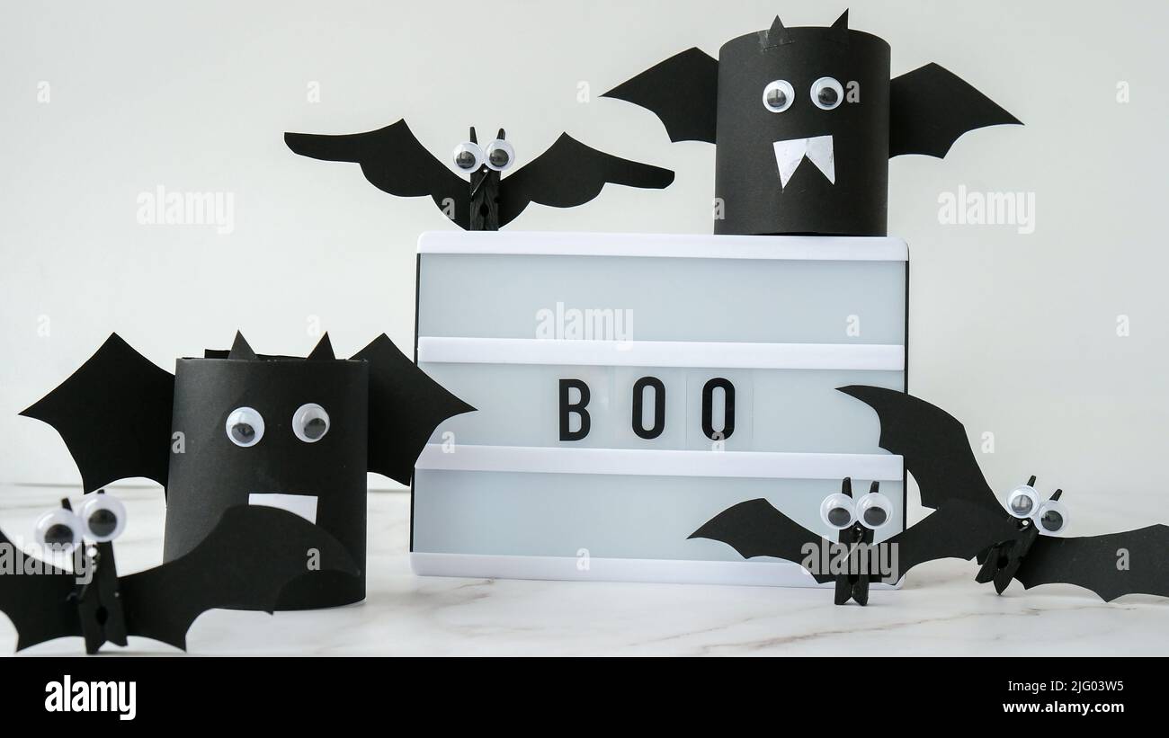 Lightbox with text BOO around paper bats. Halloween party decoration ...