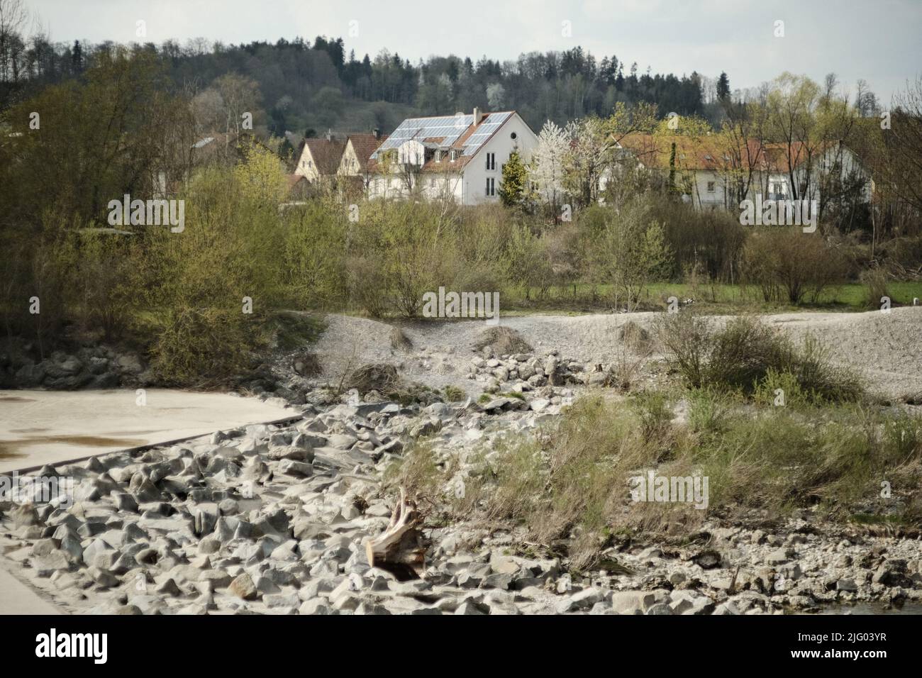 A scenic view of residential houses in a small town surrounded by green ...