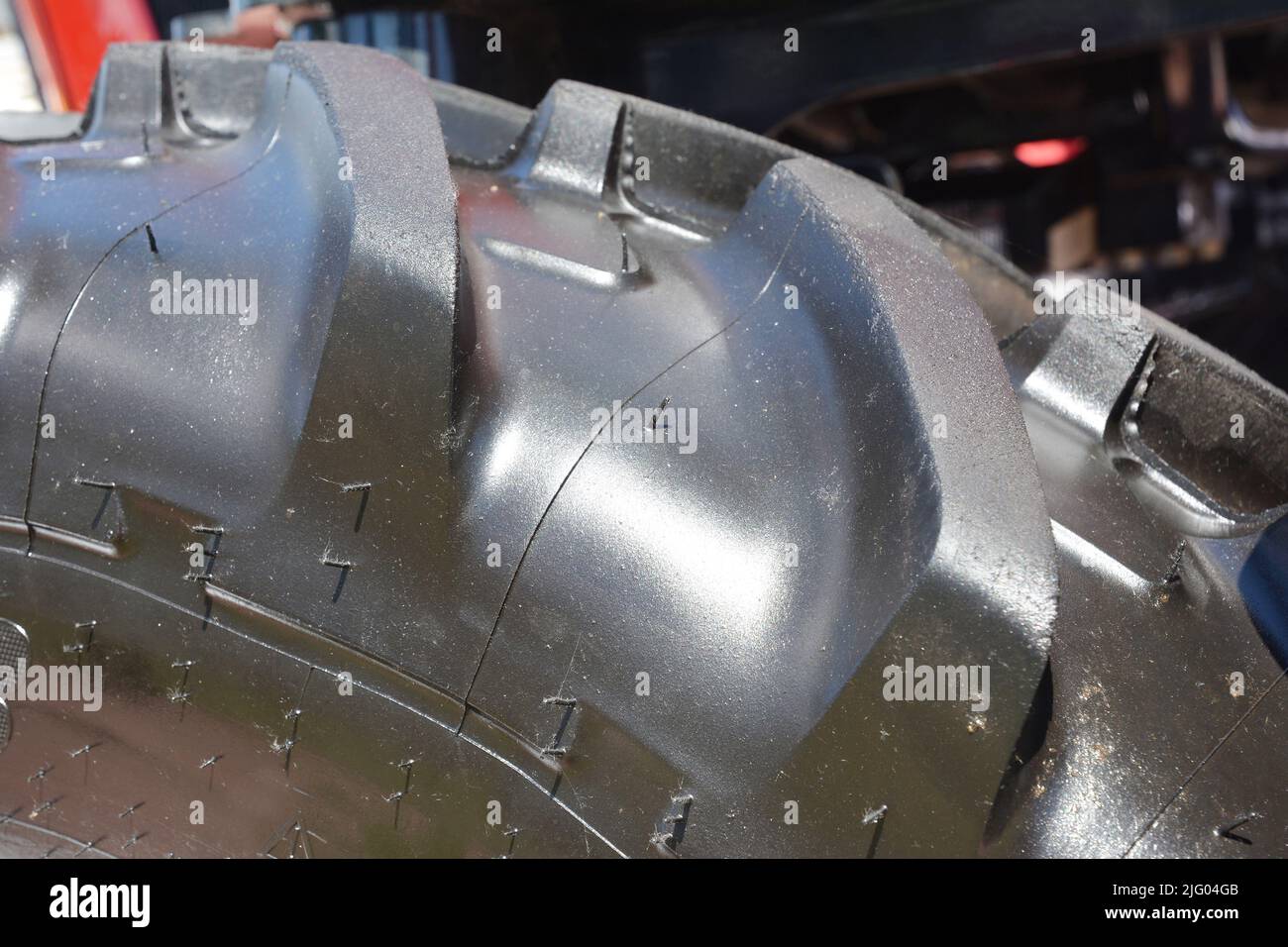 A close up on a tractor tire with big pattern block design, large ...