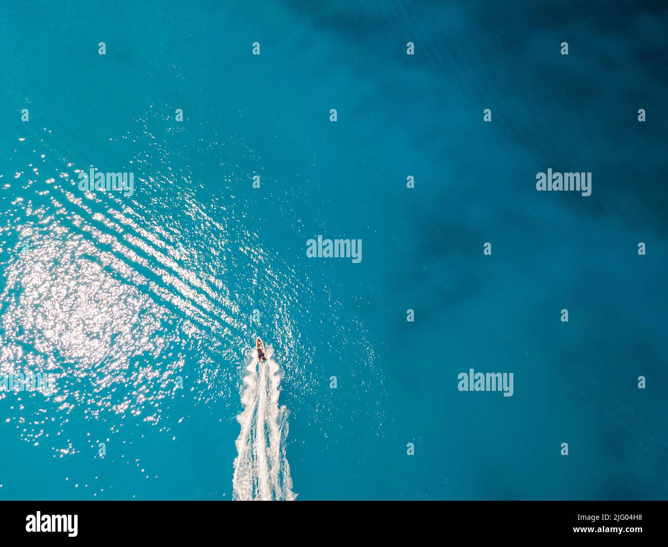 aerial view of speed boat making waves in blue sea water Stock Photo ...