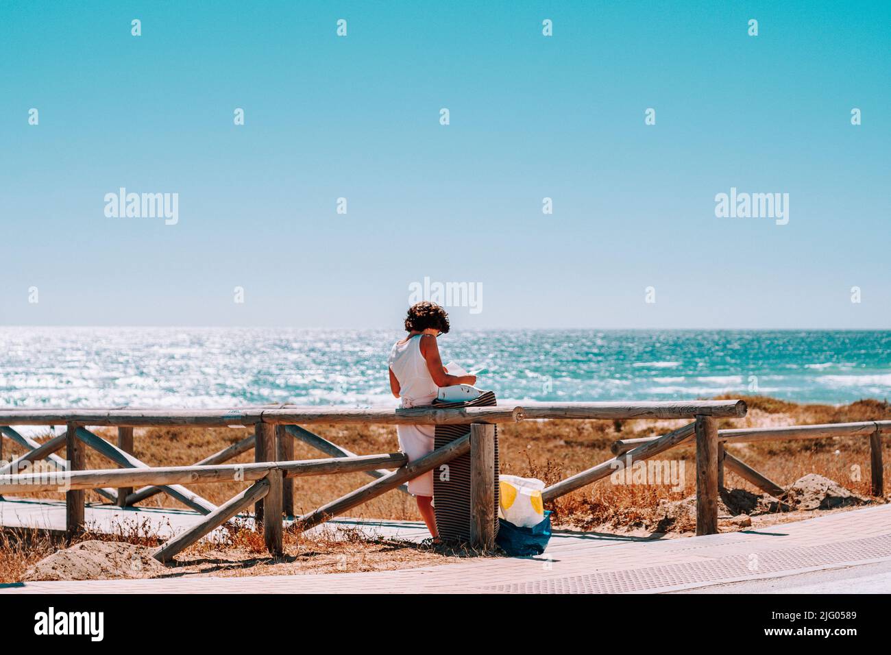 Woman pier book hi-res stock photography and images - Alamy