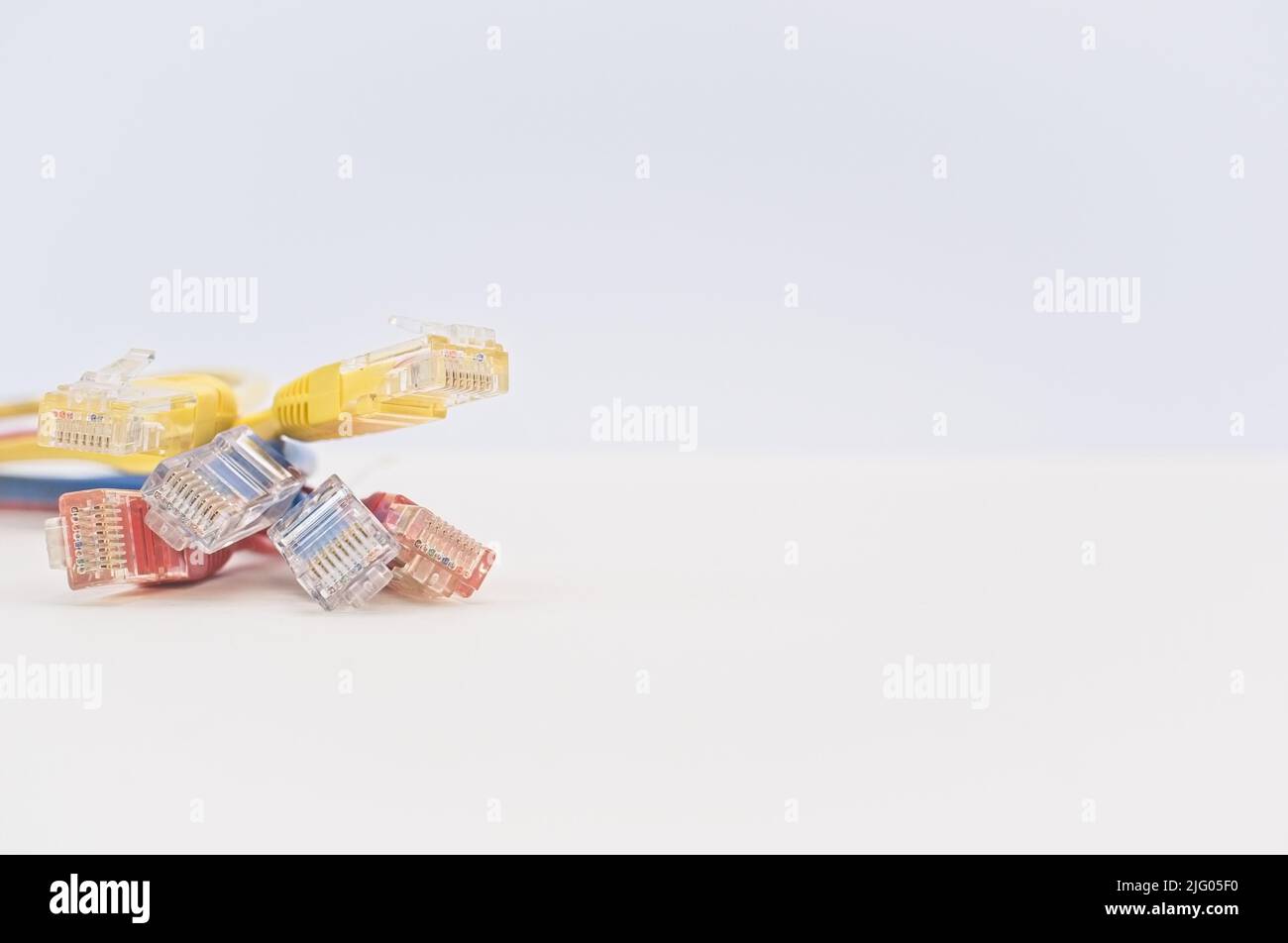 gigabit networking cables with RJ45 connectors on a bright white desk ...