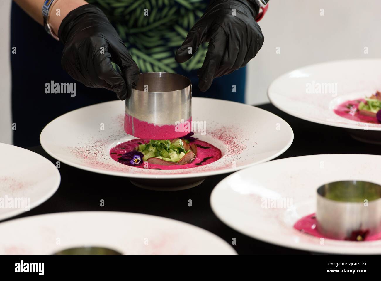 Chief serving soup with pickled beets. Preparation of borscht. . Polish ...