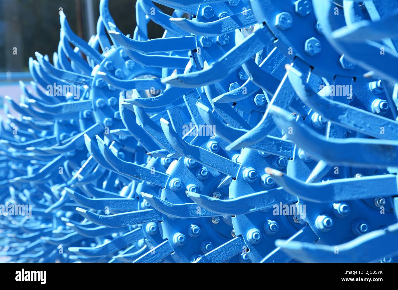 Agricultural combination tractor-soil cultivator sharp blades close up ...