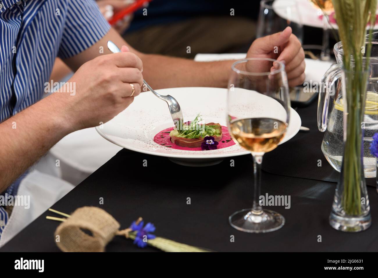 Man eats soup with pickled beets. Preparation of borscht. . Polish ...