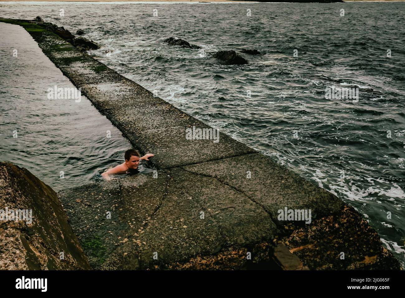 Kids swimming in the Ocean Baths swimming pool at Forster, New South ...