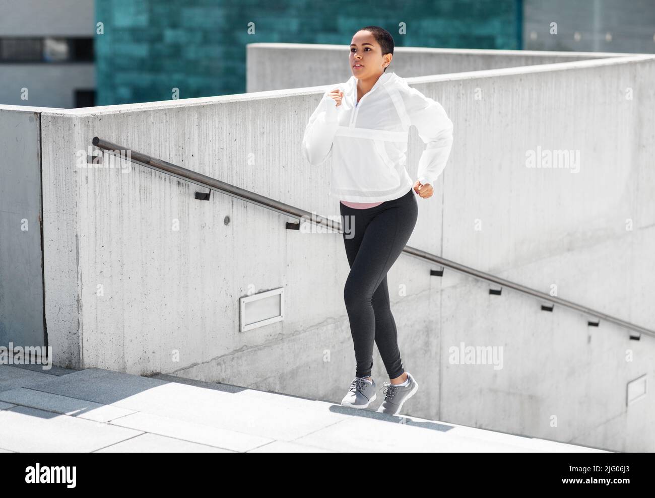 Black woman running up stairs hi-res stock photography and images - Alamy