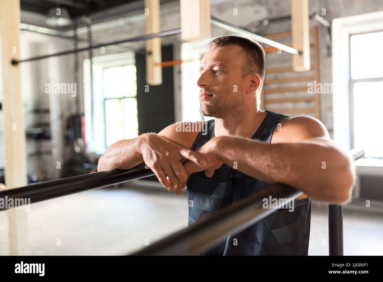 young man at parallel bars in gym Stock Photo - Alamy