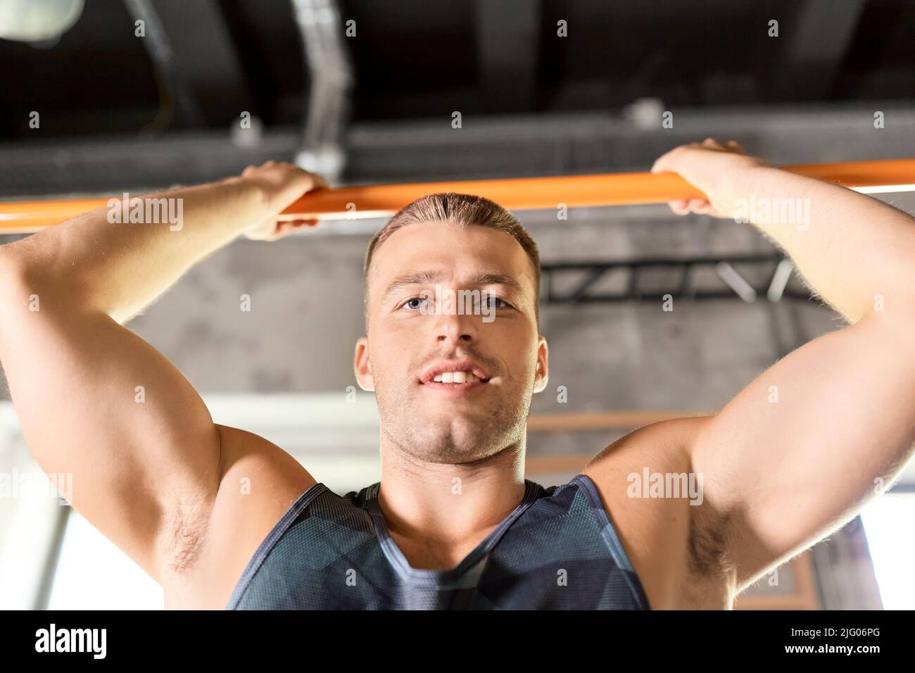 man exercising on bar and doing pull-ups in gym Stock Photo - Alamy