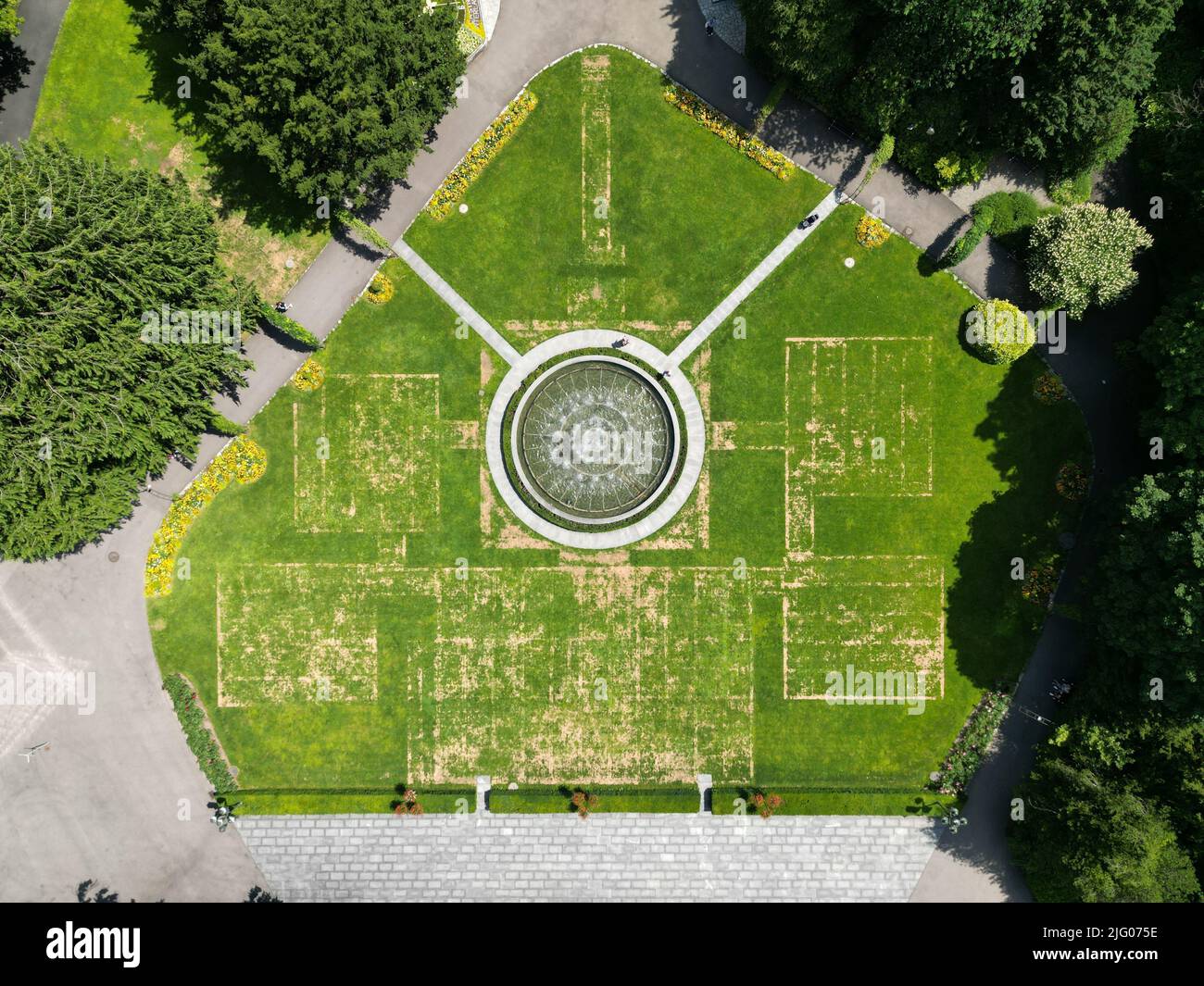 A top view of a park with fountain in the middle of green area Stock ...