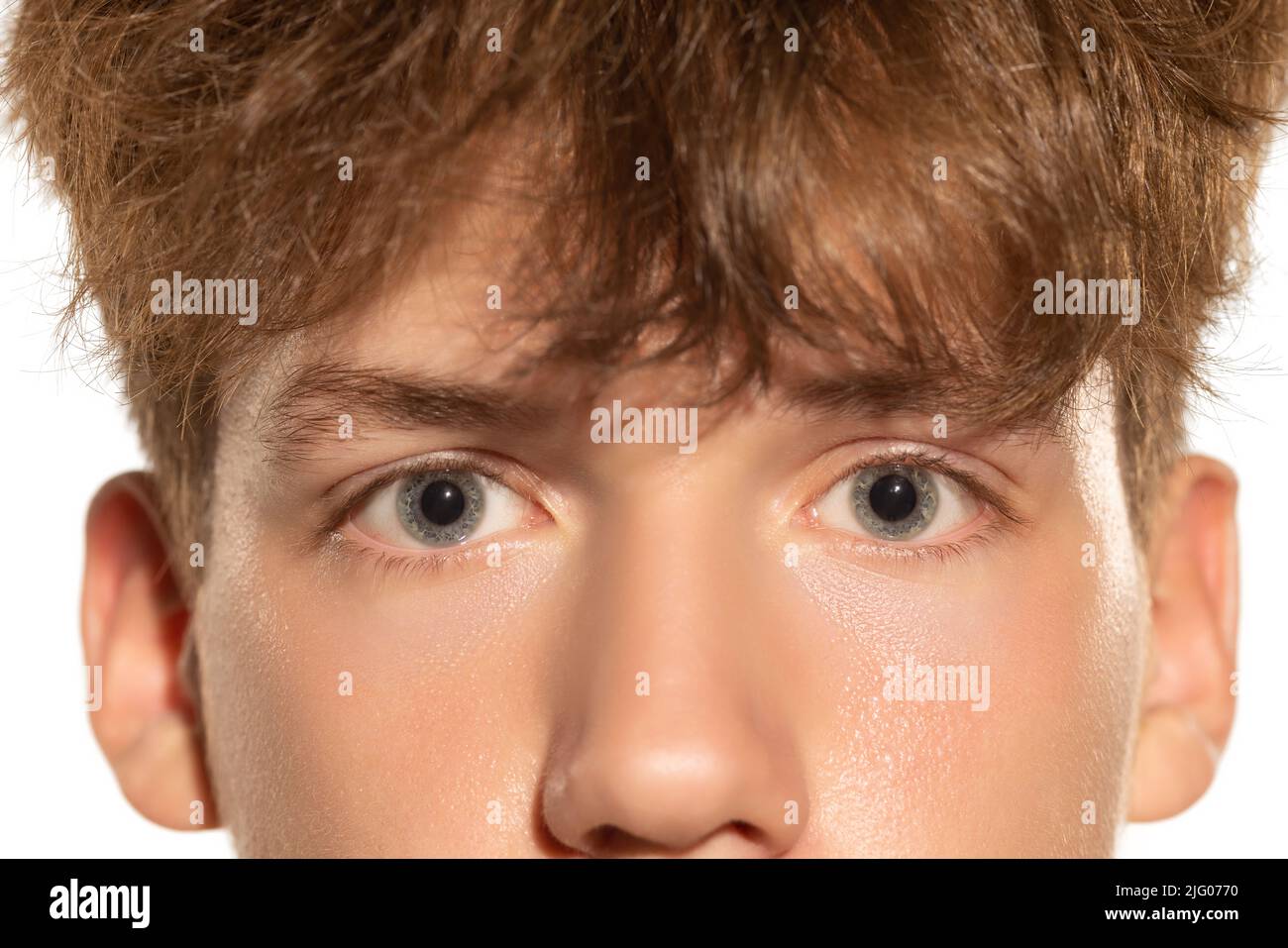 Closeup male blue eyes of young handsome man isolated on white studio ...