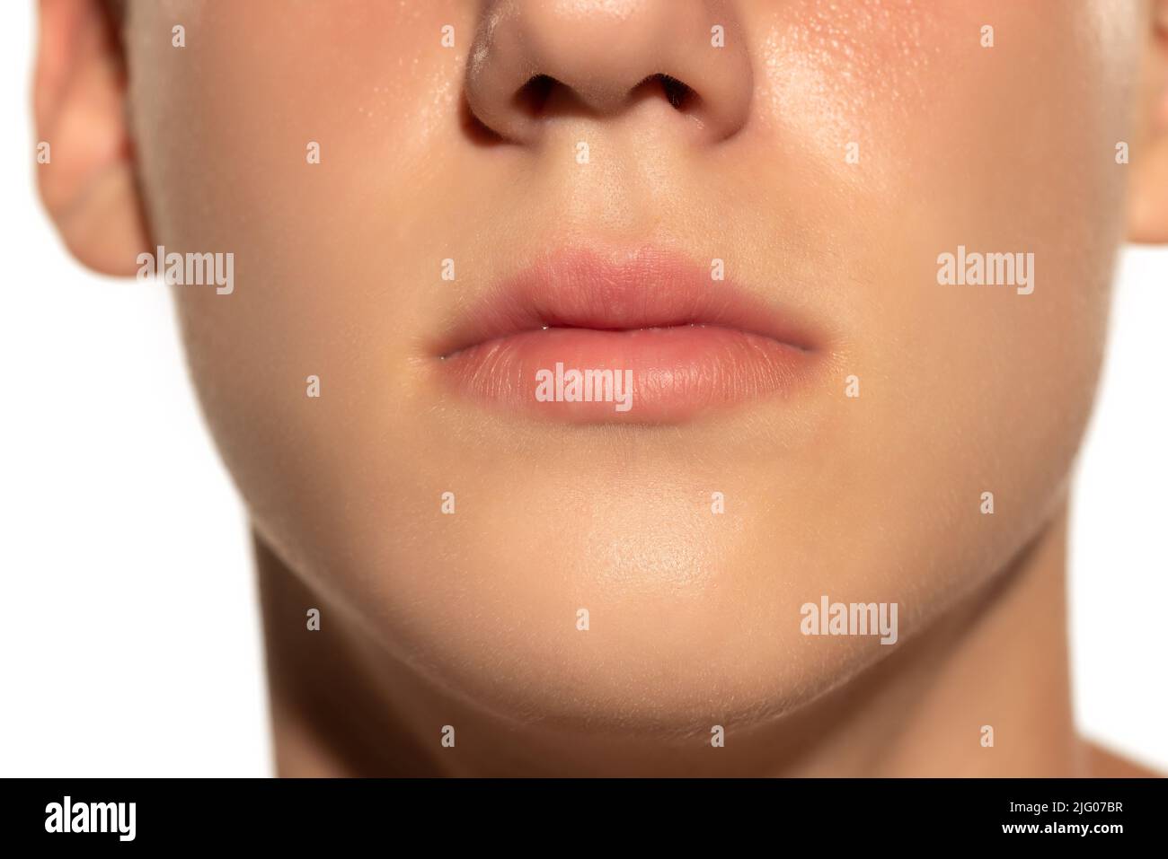 Cropped face of young man with well-kept skin isolated on white studio ...