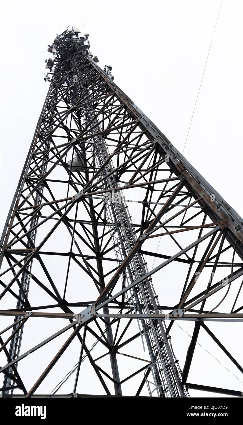 Cell phone relay tower. Metal mast. Metal structure with mounted relays ...