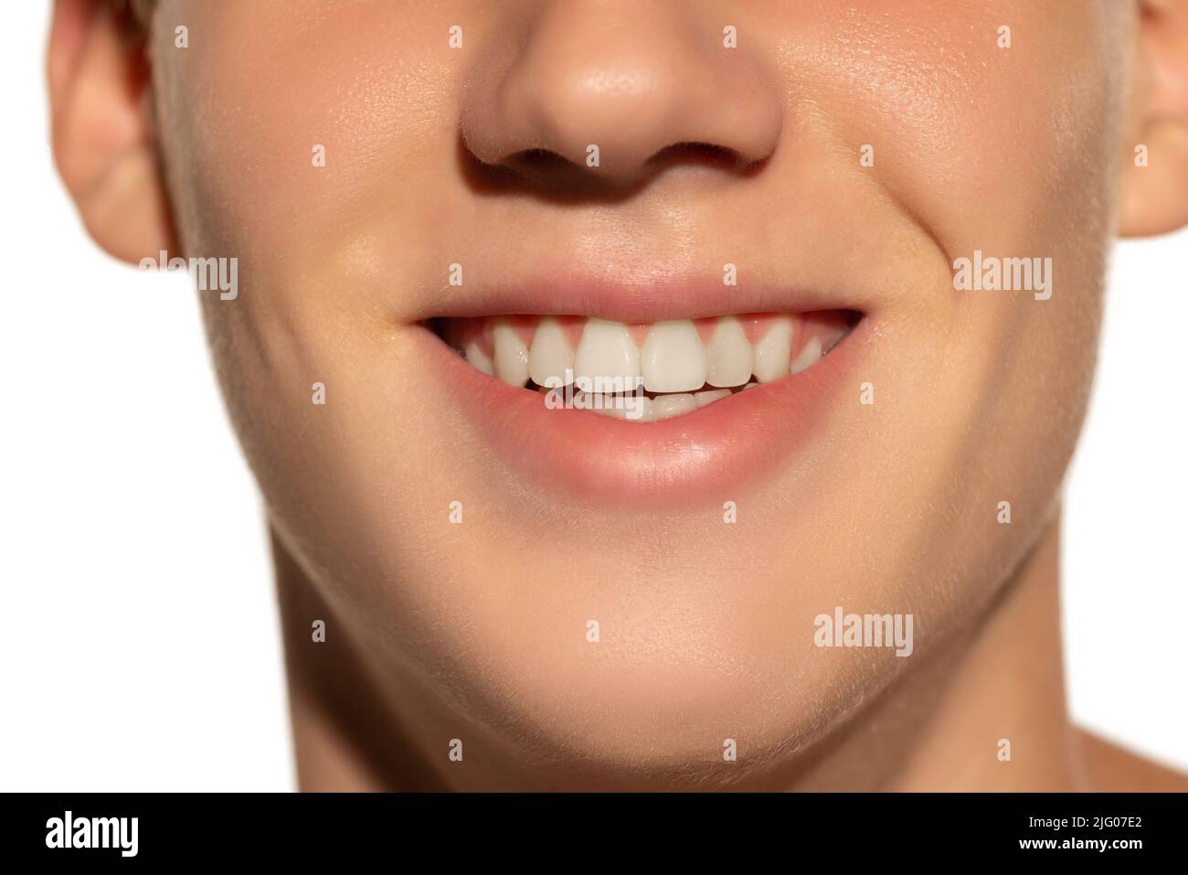 Cropped face of young man with well-kept skin isolated on white studio ...