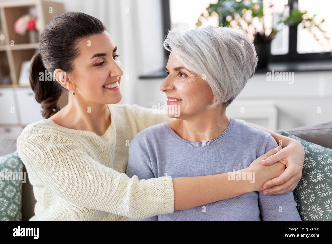 Older mother and daughter hugging home hi-res stock photography and images - Alamy