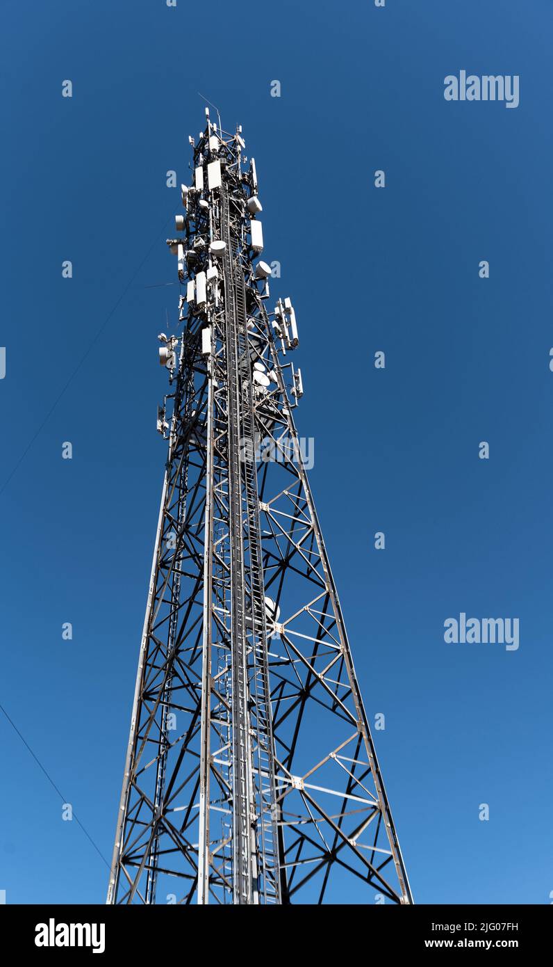 Cell phone relay tower. Metal mast. Metal structure with mounted relays ...
