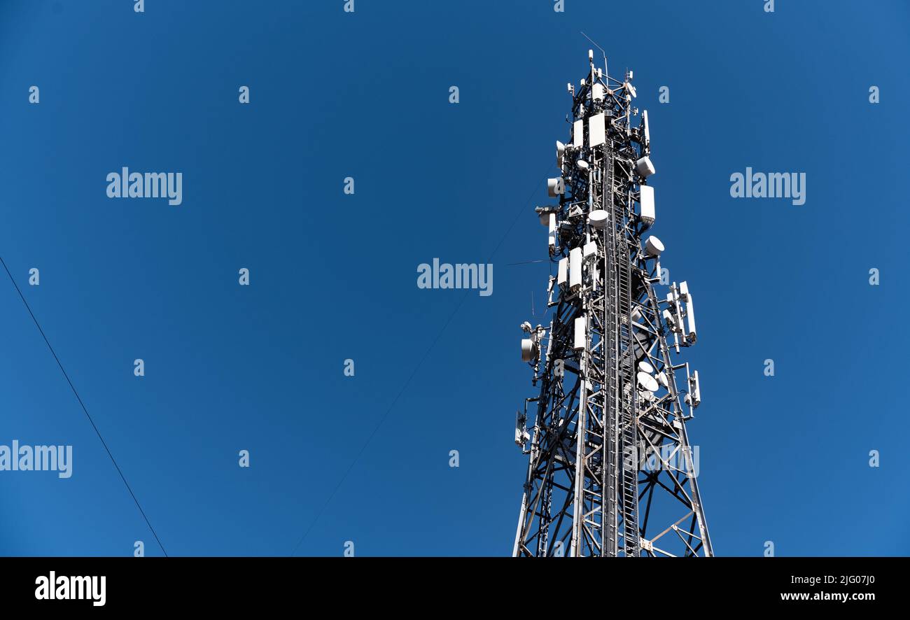 Cell phone relay tower. Metal mast. Metal structure with mounted relays ...