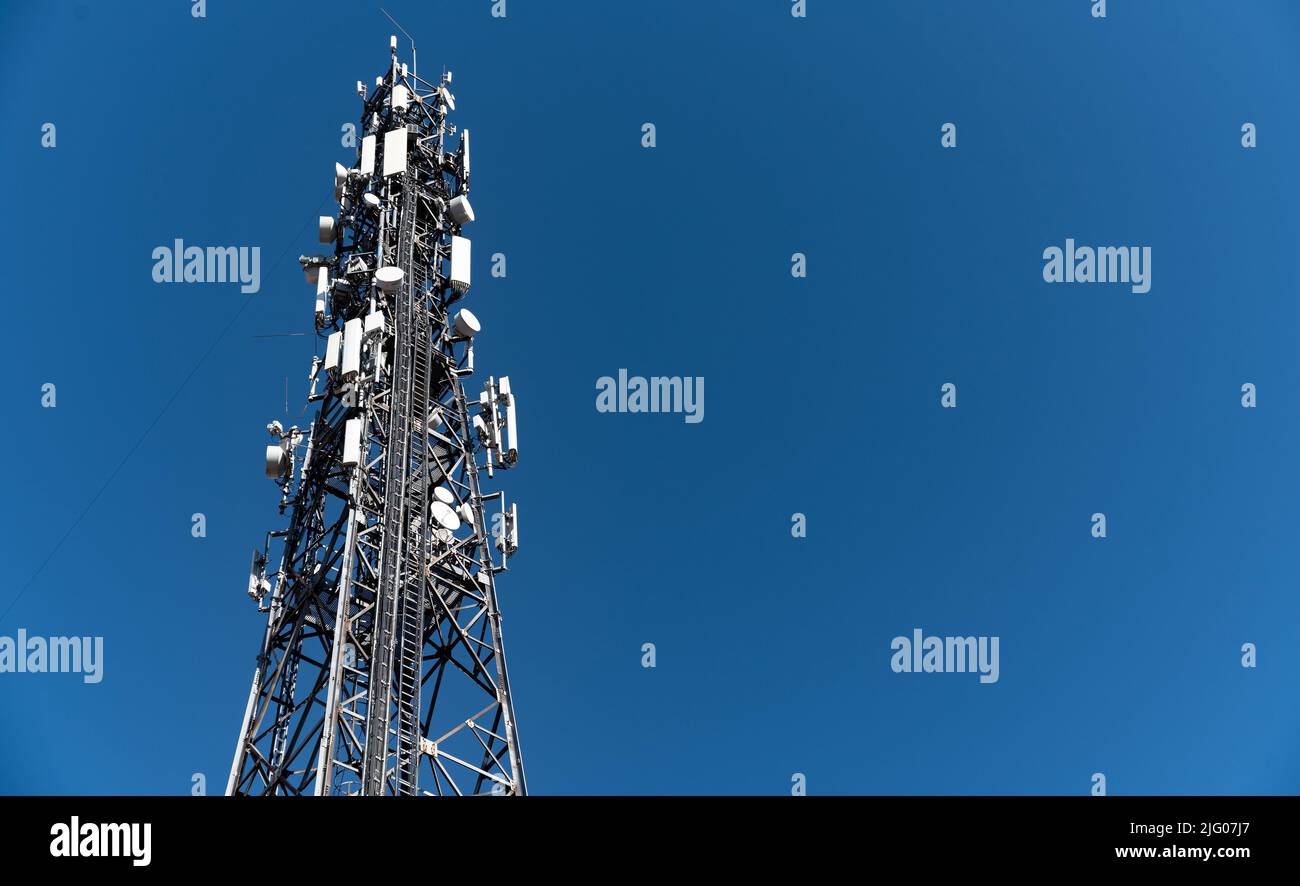 Cell phone relay tower. Metal mast. Metal structure with mounted relays ...