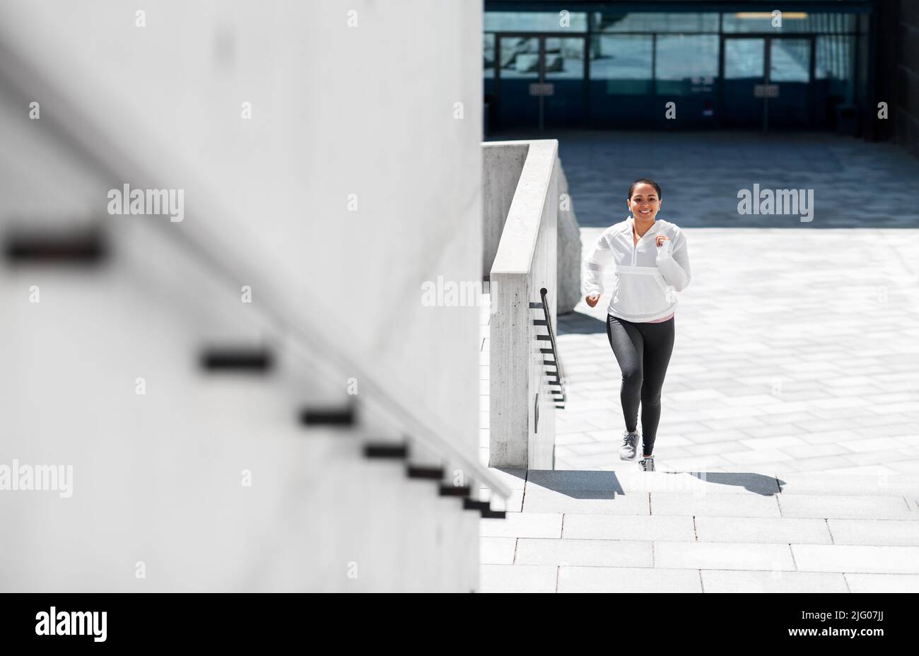 Young woman jogging upstairs in hi-res stock photography and images - Alamy