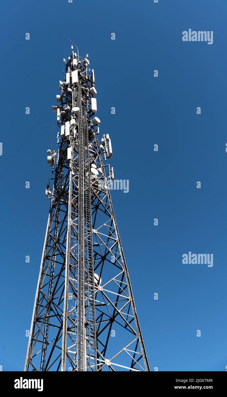 Cell phone relay tower. Metal mast. Metal structure with mounted relays ...