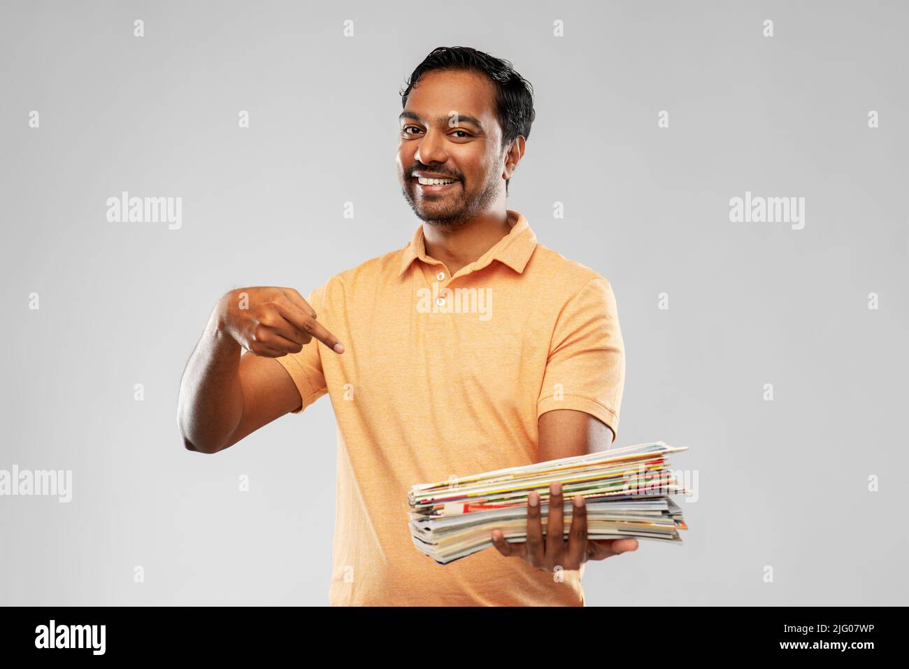 smiling young indian man sorting paper waste Stock Photo - Alamy