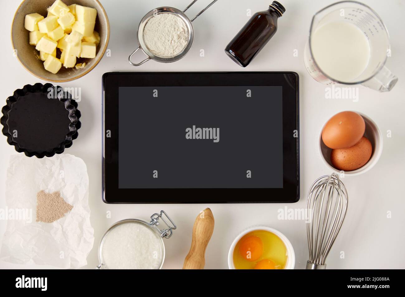 tablet computer and cooking ingredients on table Stock Photo - Alamy