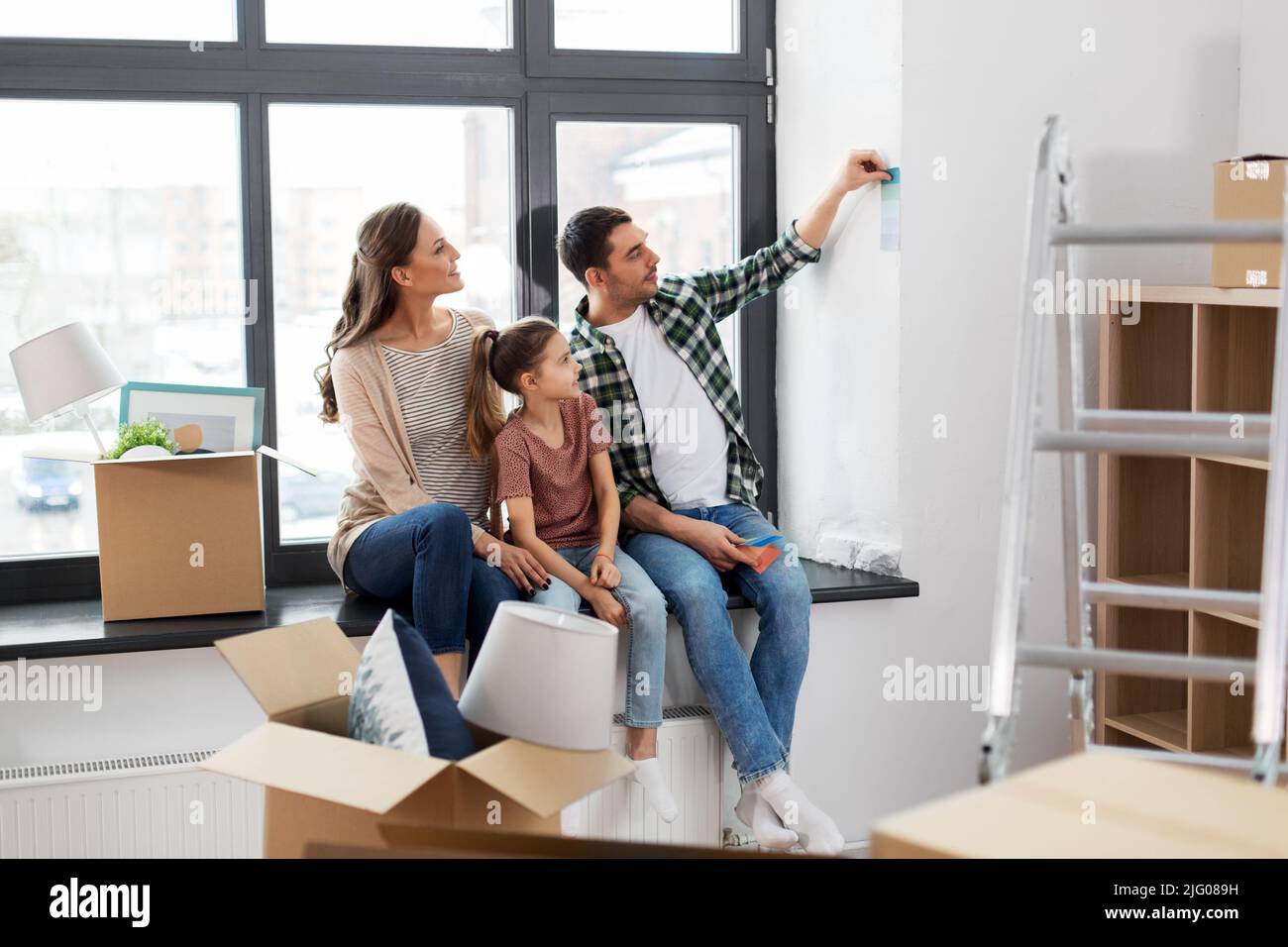 happy family with color palette moving to new home Stock Photo - Alamy