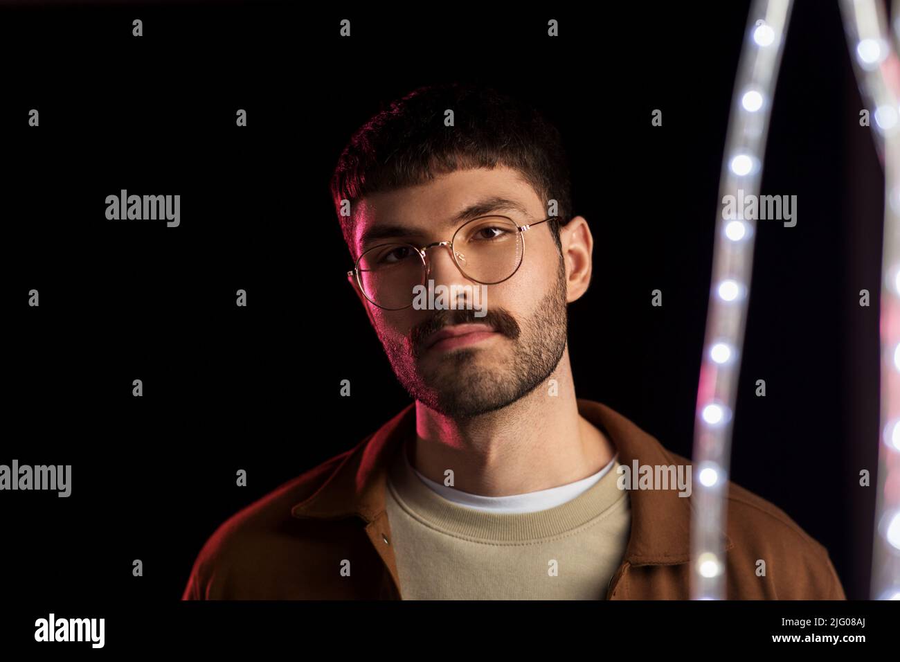 man in glasses over neon lights at nightclub Stock Photo - Alamy