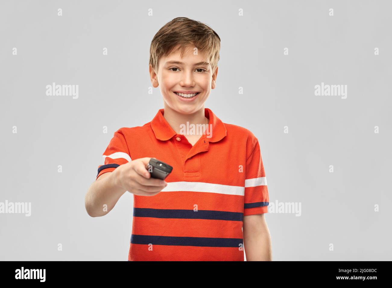 smiling boy with tv remote control Stock Photo - Alamy