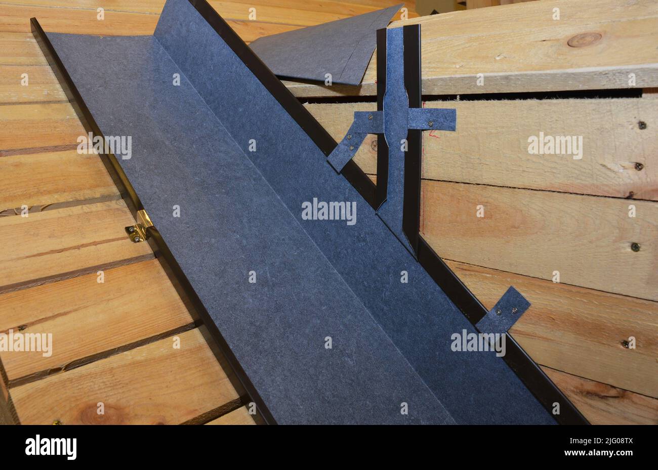 The waterproofing of a roofing problem area near a mansard roof window ...